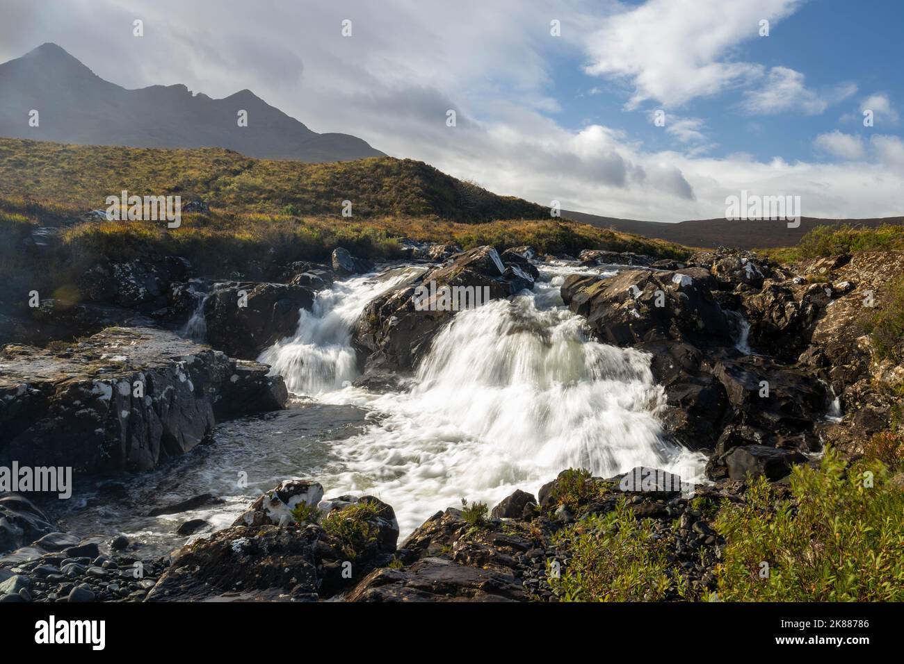 A view of the Sligachan waterfalls with views of the Cuillin mountains ...