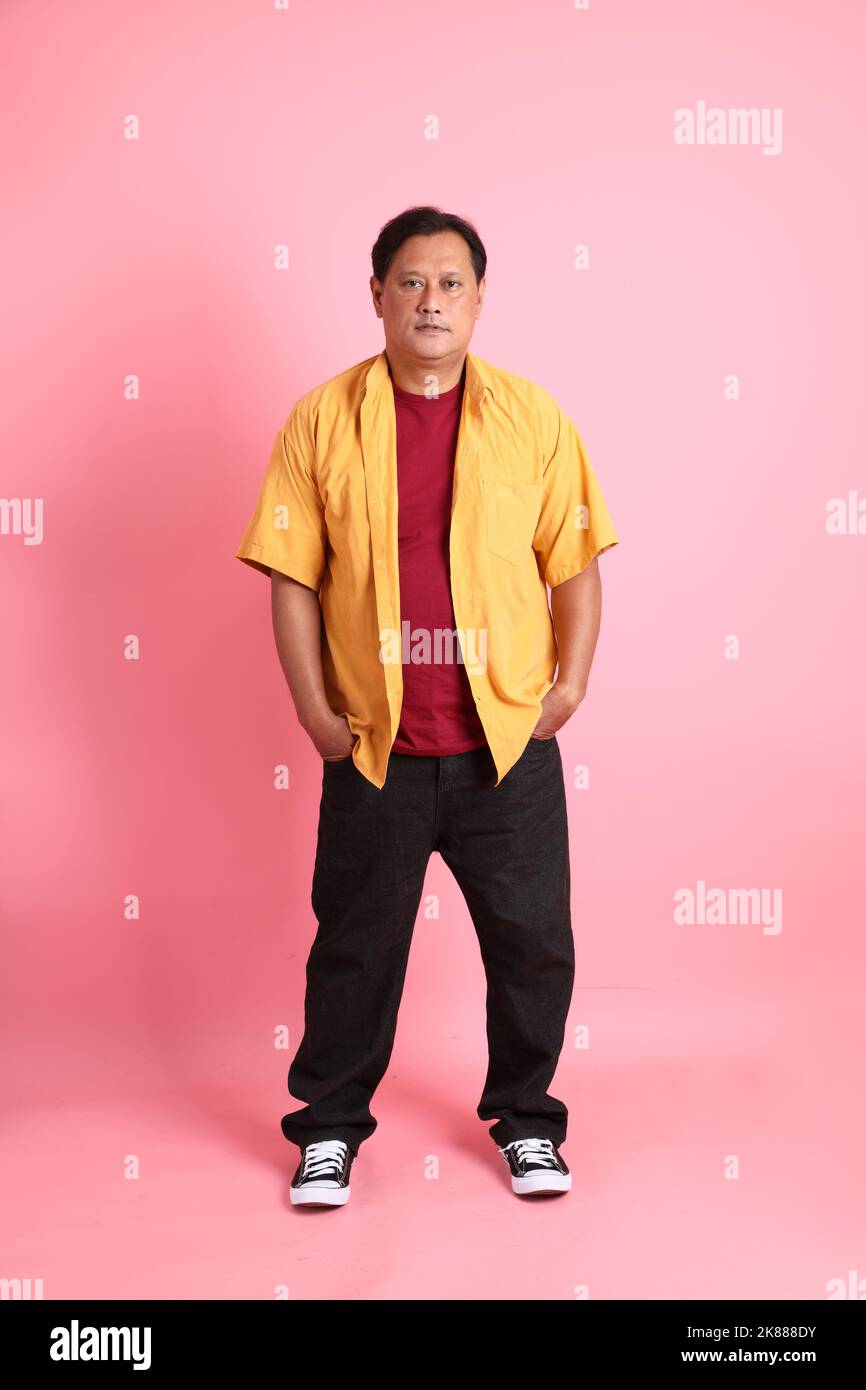 The 40s adult overweight Asian man standing on the pink background ...