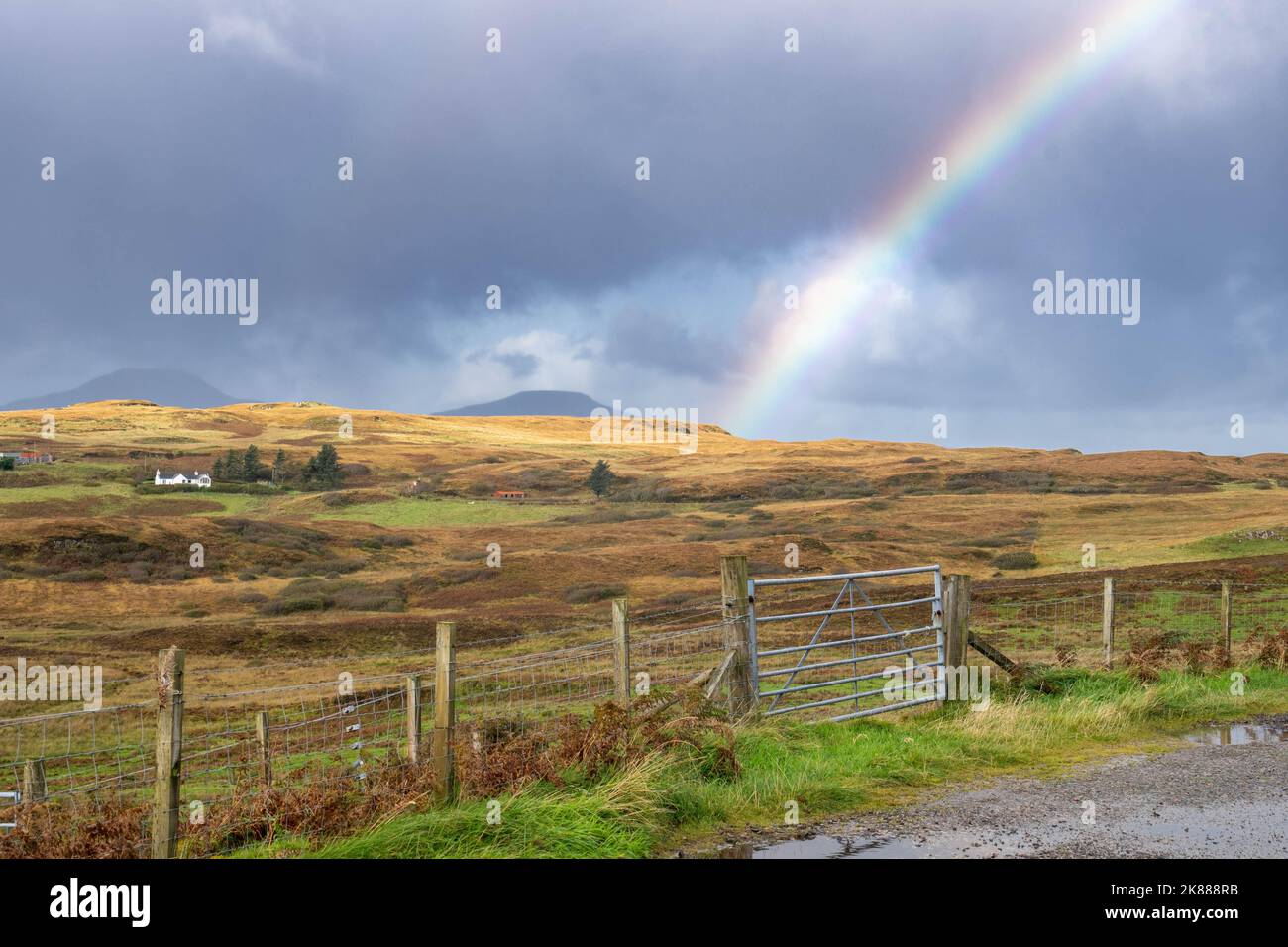A view of a rainbow over the hills on the Isle of Skye Scotland Uk ...