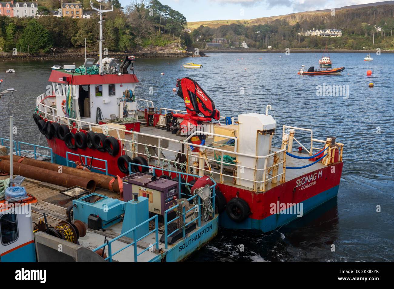 A fishing trawler coming into Portree harbour on the Isle of Skye ...