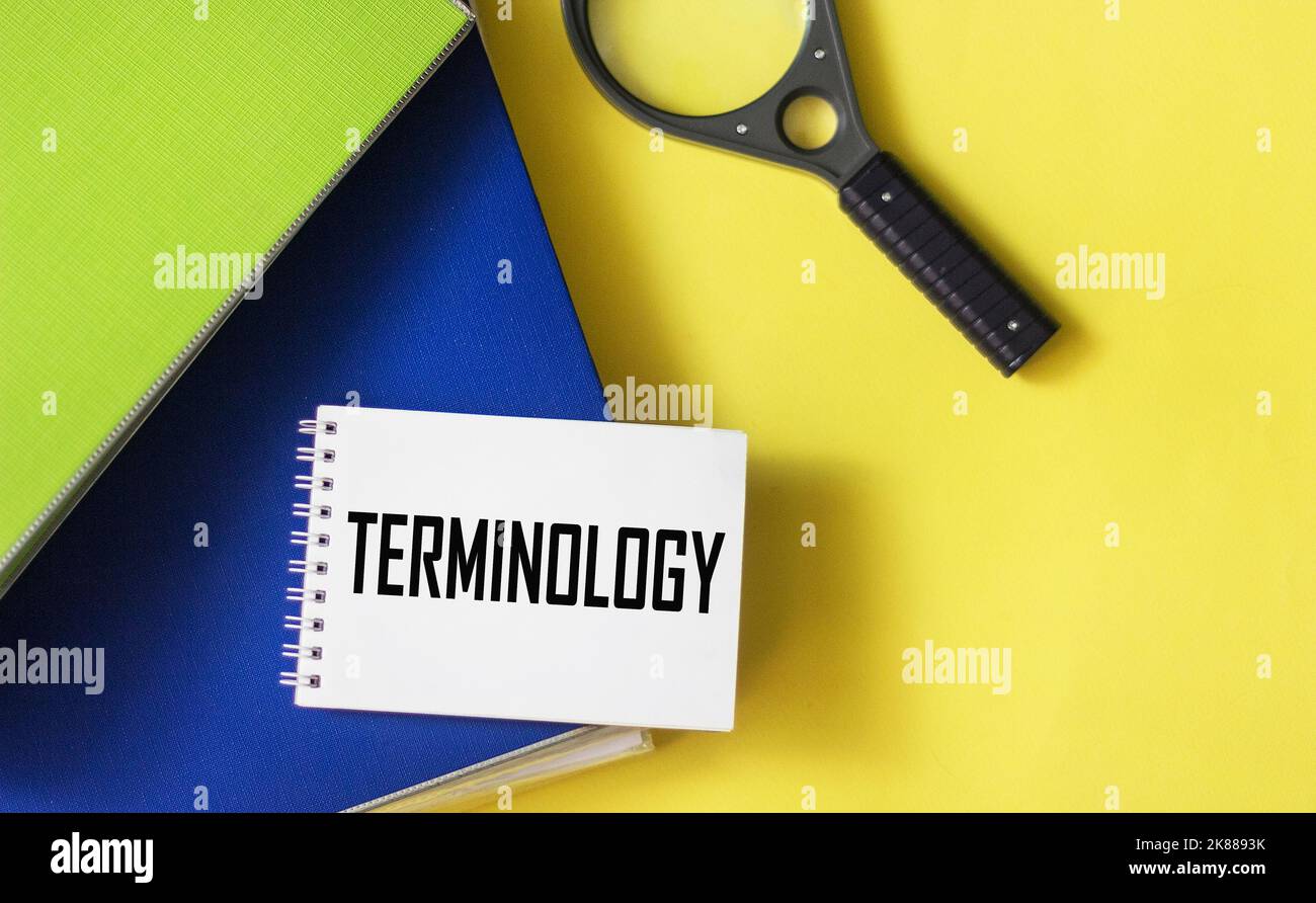 Notepad with text TERMINOLOGY on yellow background with blue folders ...