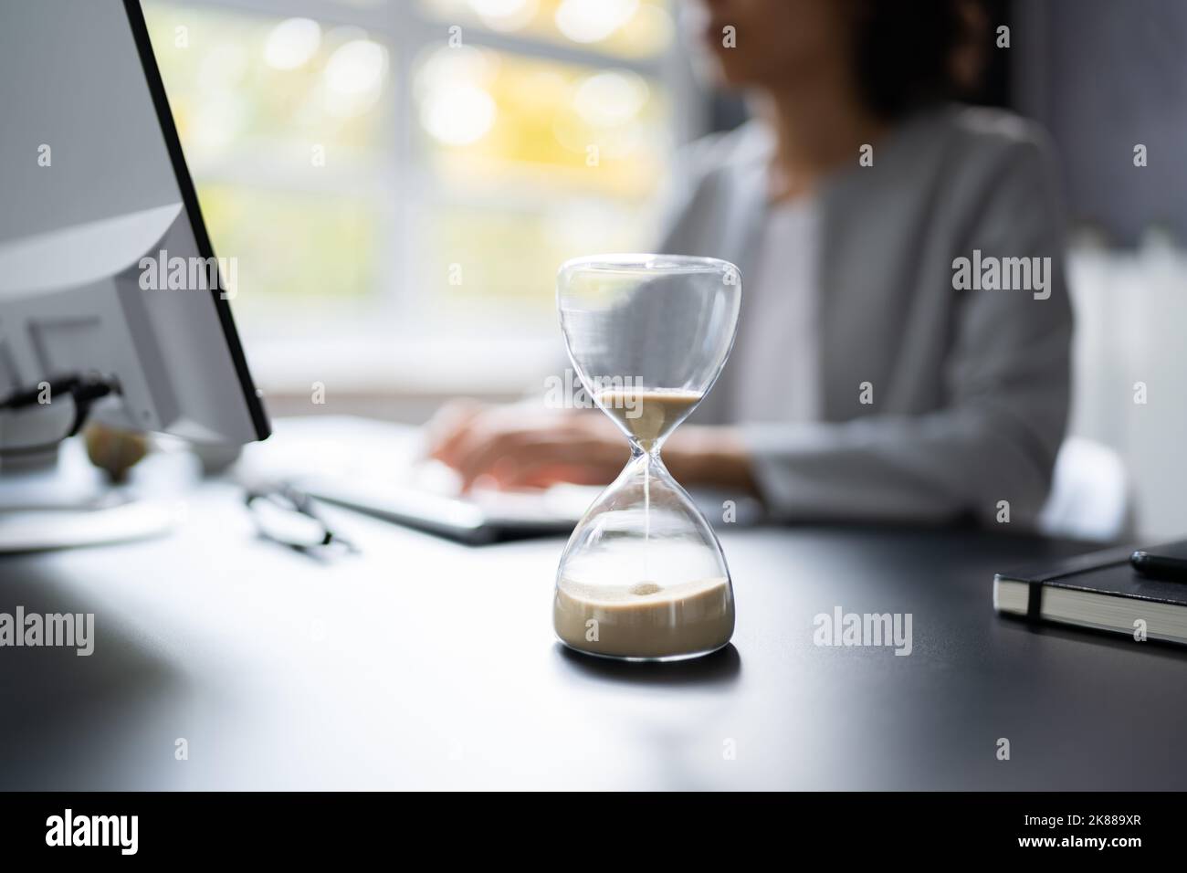 Black Accountant Woman Working With Invoice And Hourglass Stock Photo ...