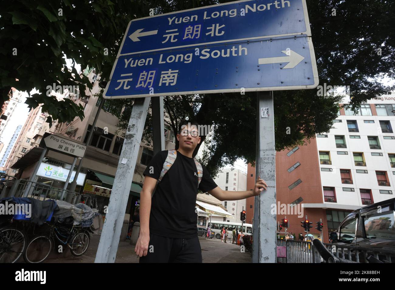 Gary Yau, founder of the Road Research Society, posing with an old road ...