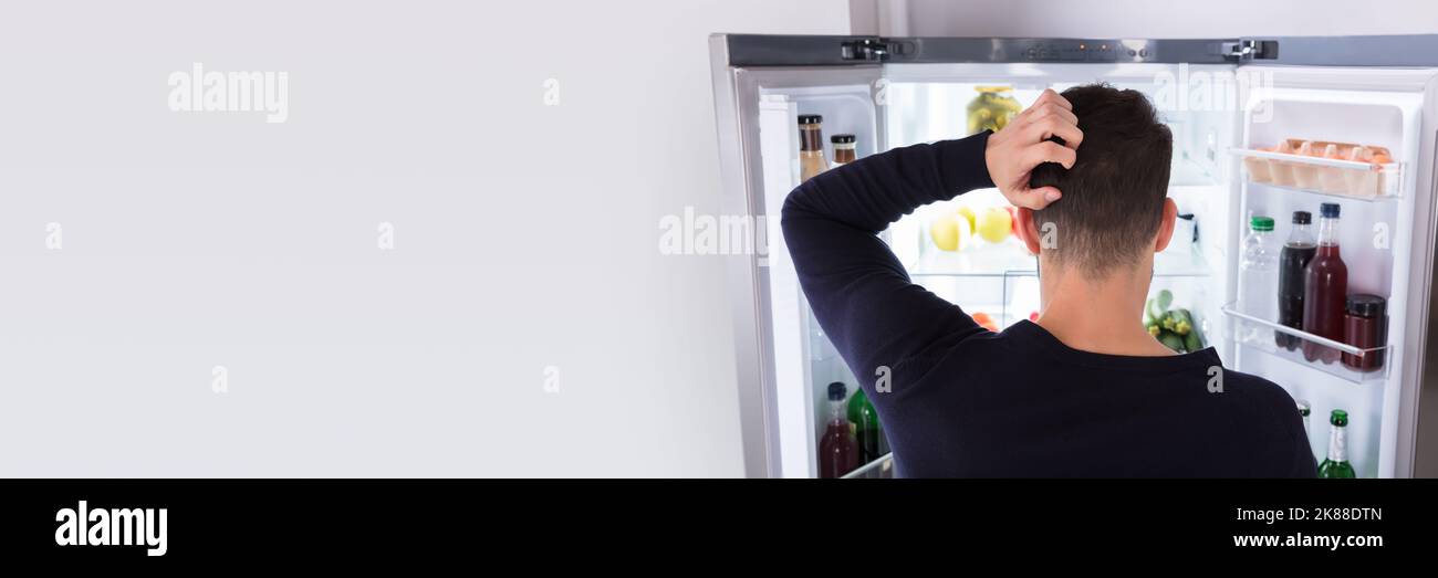 Confused Man Looking In Open Refrigerator. Fridge Appliance Stock Photo ... Confused Man Looking In Open Refrigerator. Fridge Appliance Stock Photo ...