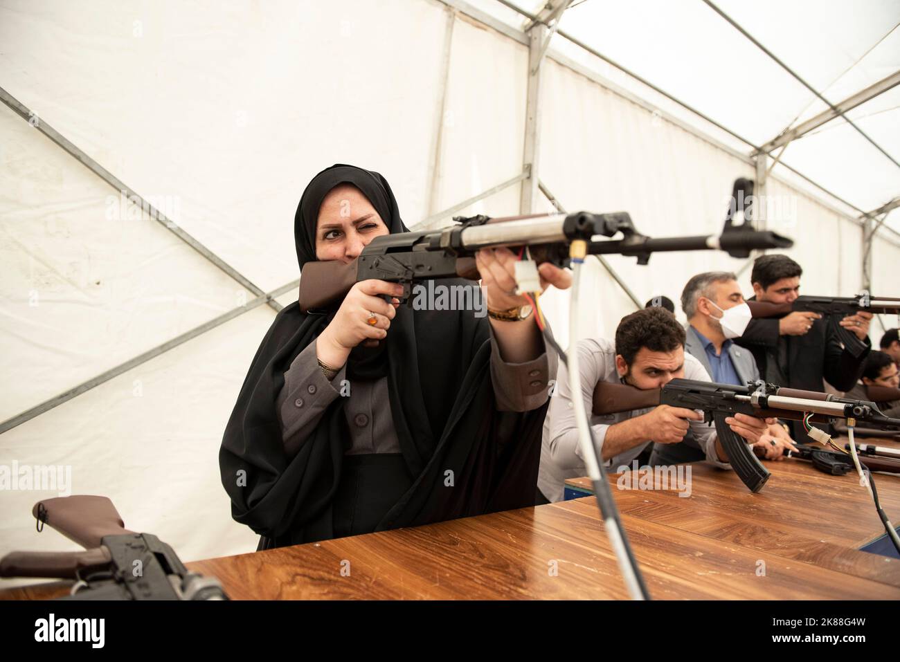 A woman practice shooting with shooting simulators made in Iran at a ...
