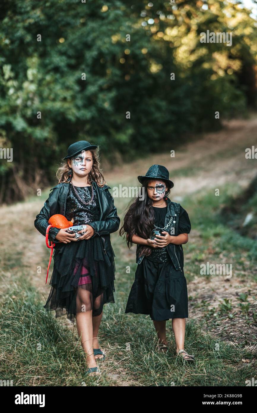 Teenage girls in hard rock costumes celebrate Halloween party Stock ...