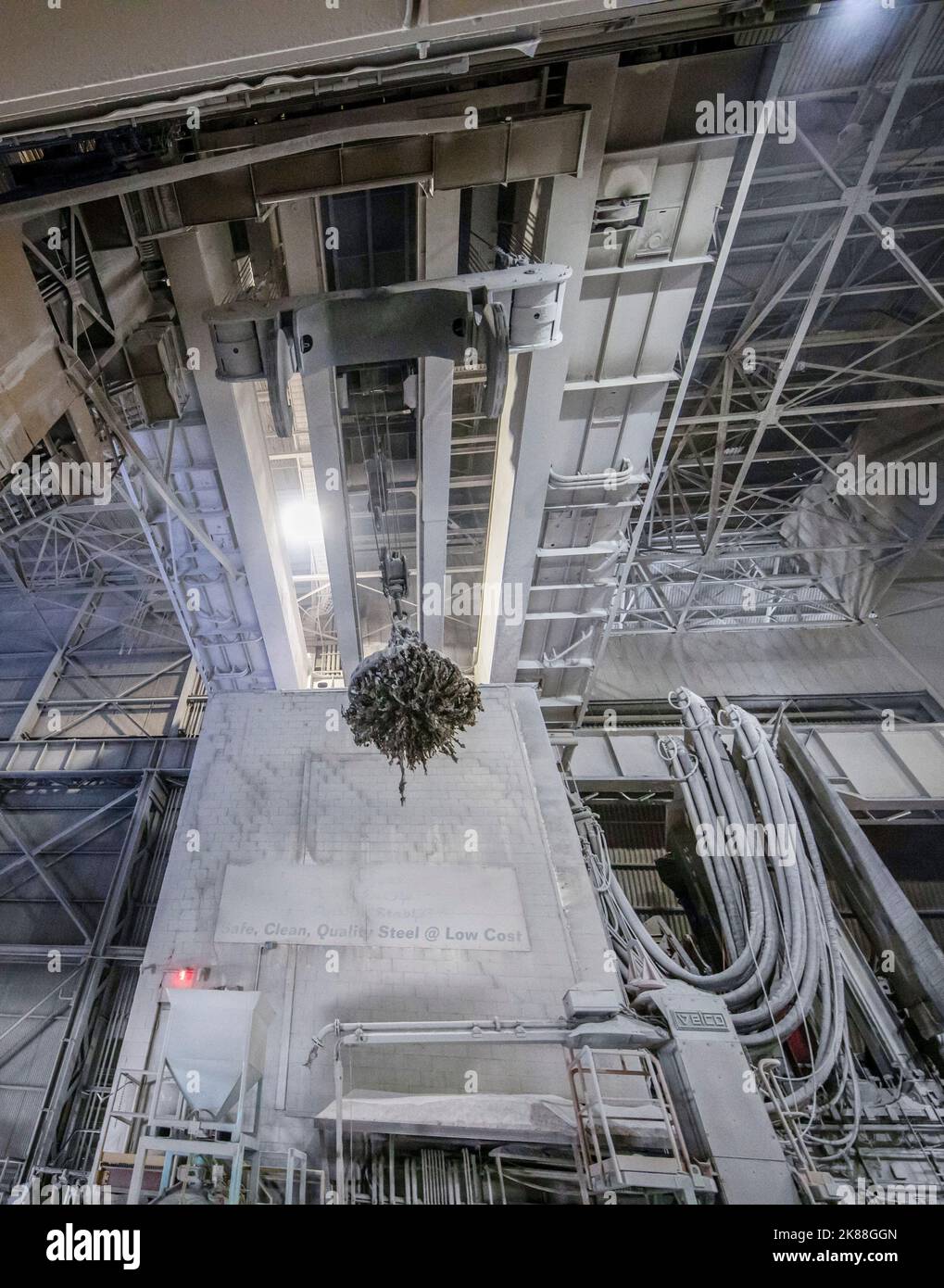 Magnet lifting metal at steel mill Stock Photo - Alamy