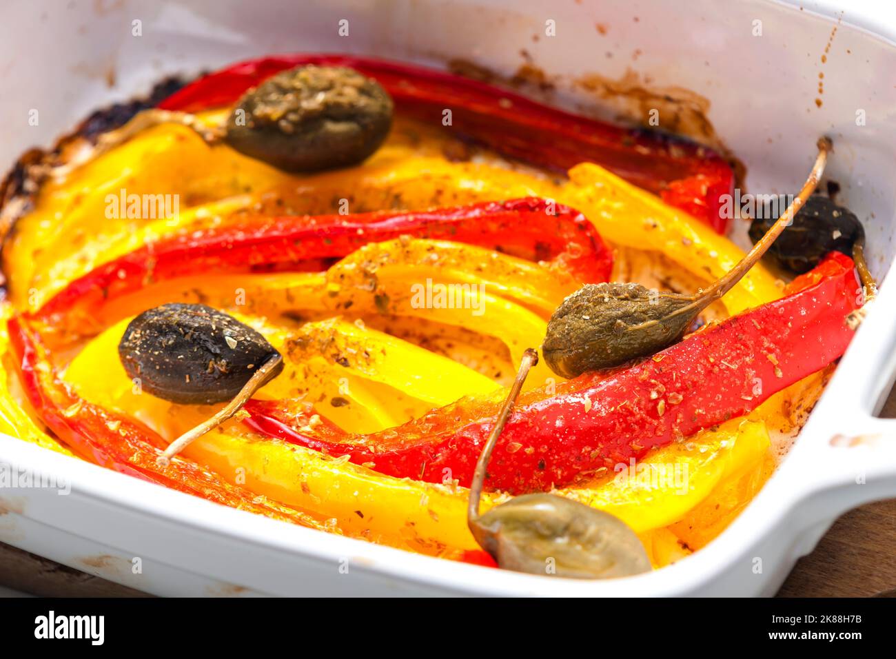 baked red and yelllow peppers with capers Stock Photo - Alamy