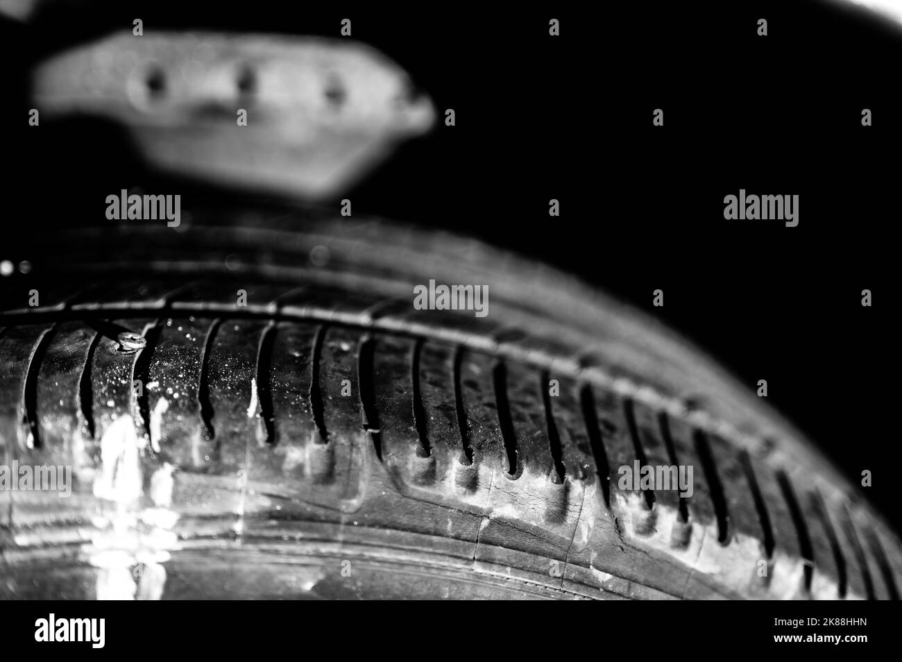 screw protruding from the tread of a tire causing a flat Stock Photo ...