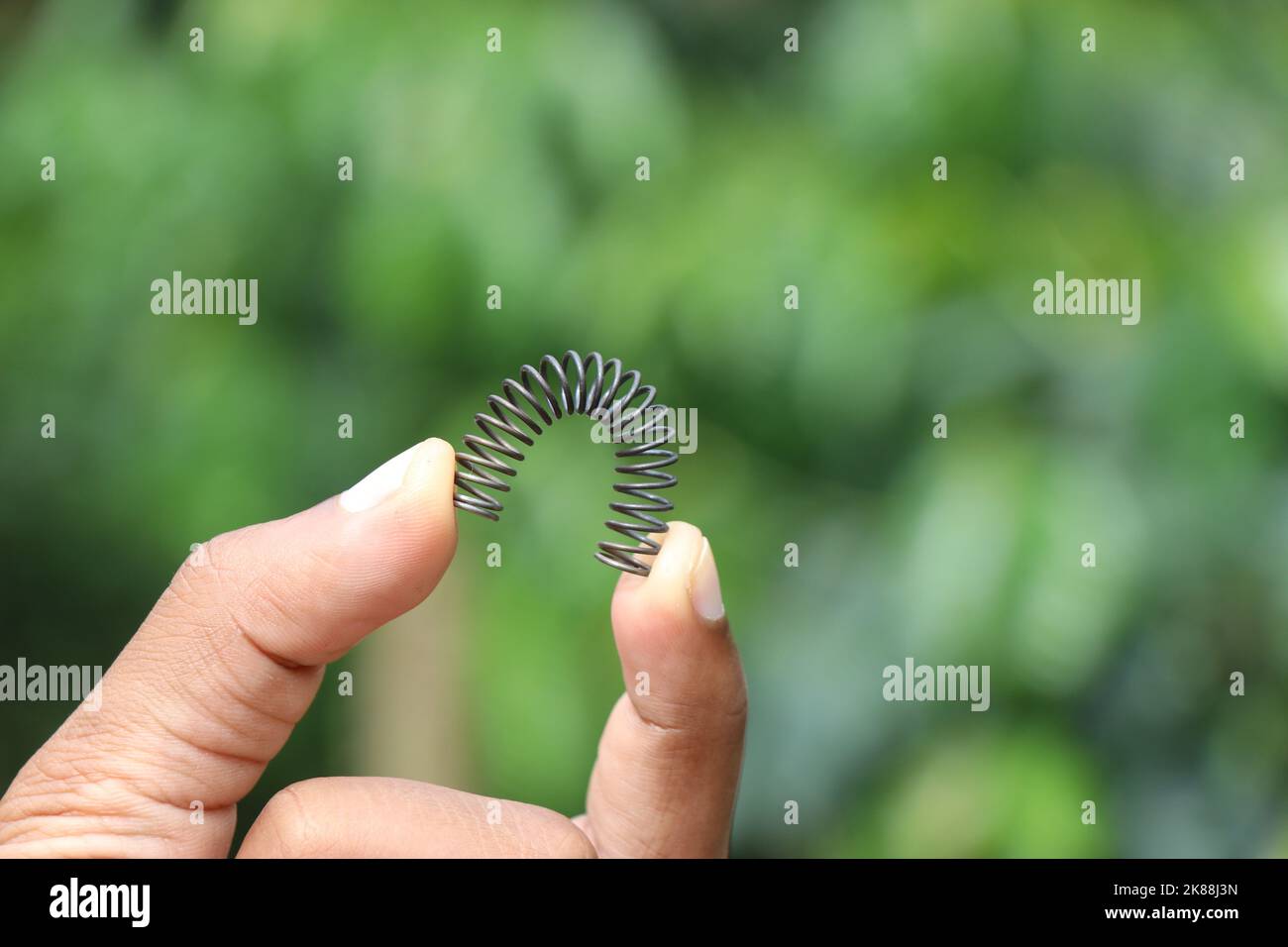 Compression springs held in hand bent to show its ability to absorb ...