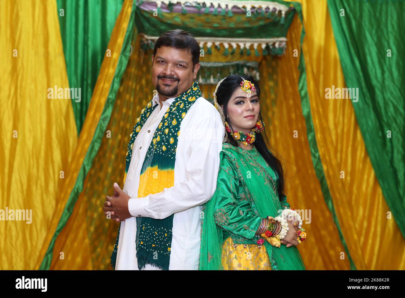 Bride and Groom at Traditional Mayoon ceremony at colorfully decorated ...