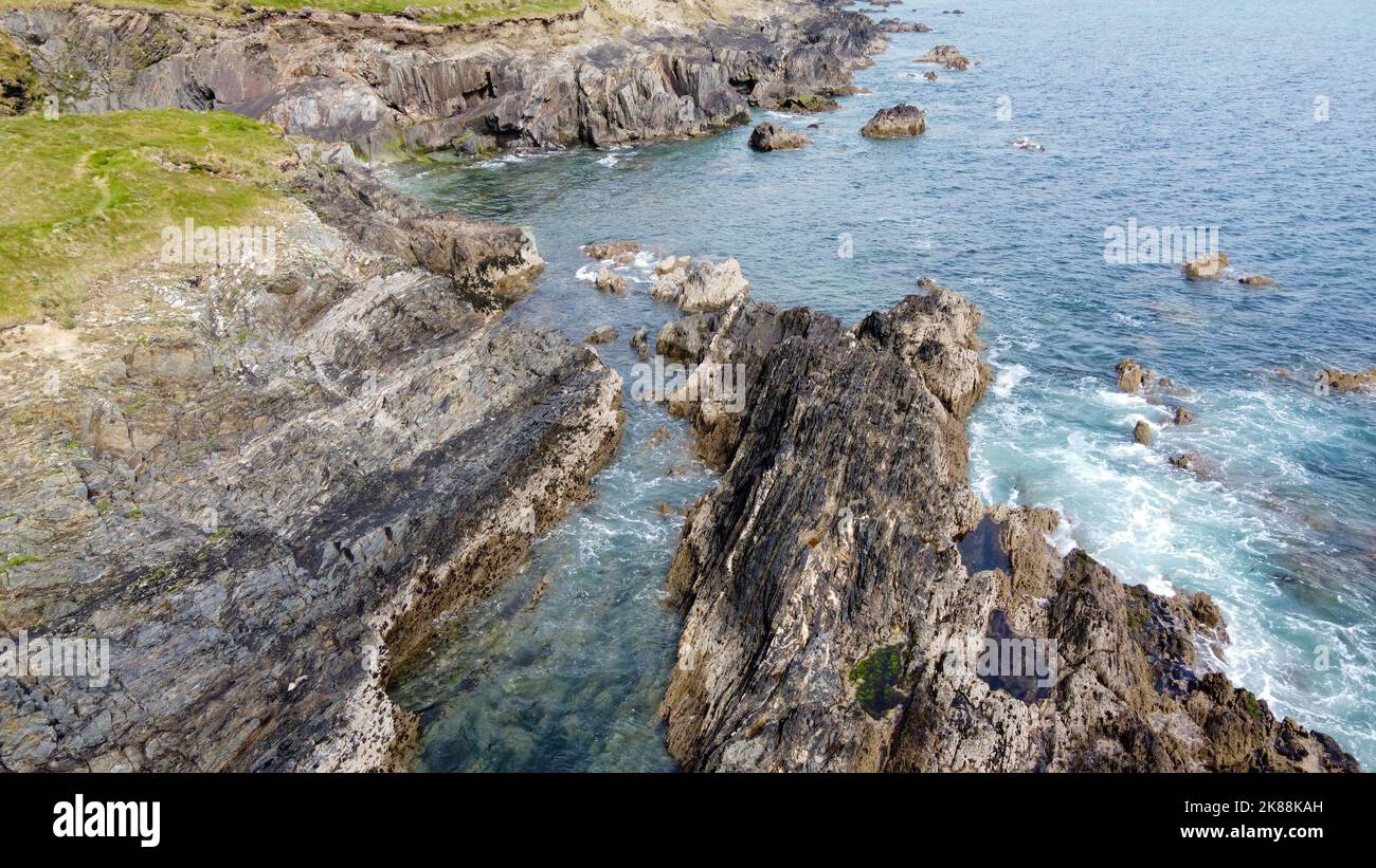 Beautiful coastal cliffs of the Atlantic Ocean. White foam on the sea ...