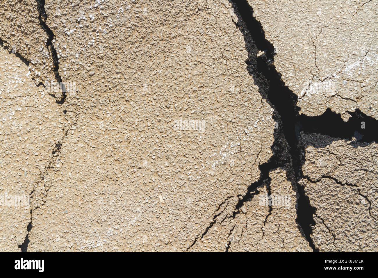 Ruins on road. Cracked asphalt. Deep crack in road. Faults in ground ...