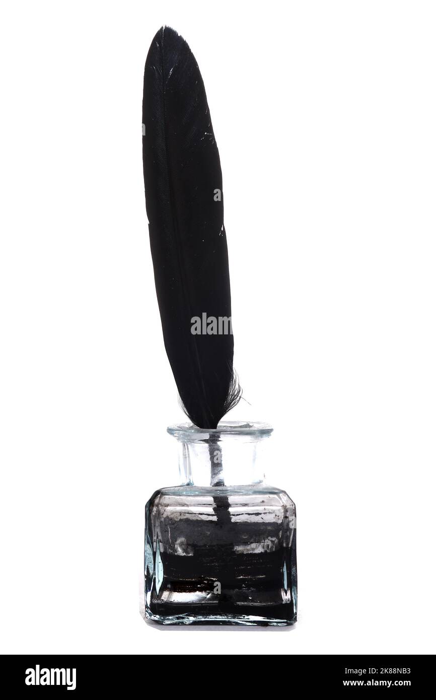 Black writing quill in a glass bottle full of ink isolated over white ...