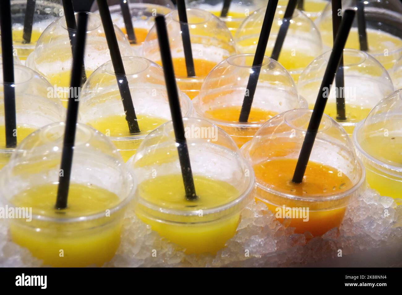 Close-up view of plastic cups of fresh fruit juice with straw Stock ...