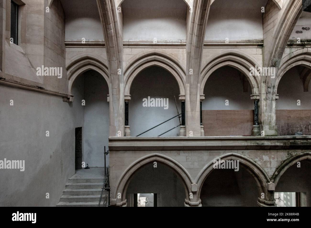 An abandoned cathedral with ornamented arches and a staircase Stock ...