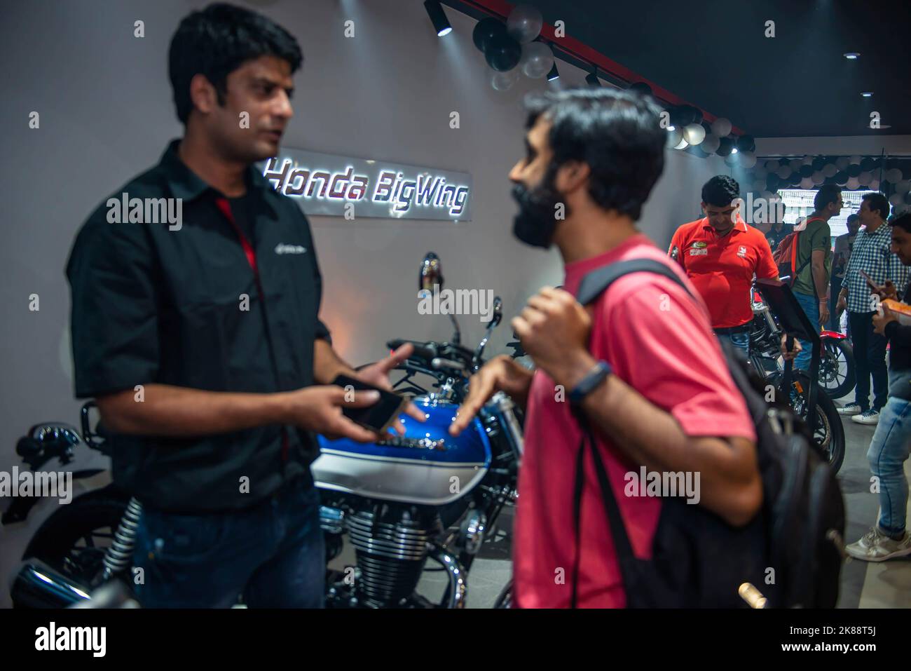 A salesman speaks with a customer at a Honda BigWing showroom. Honda ...