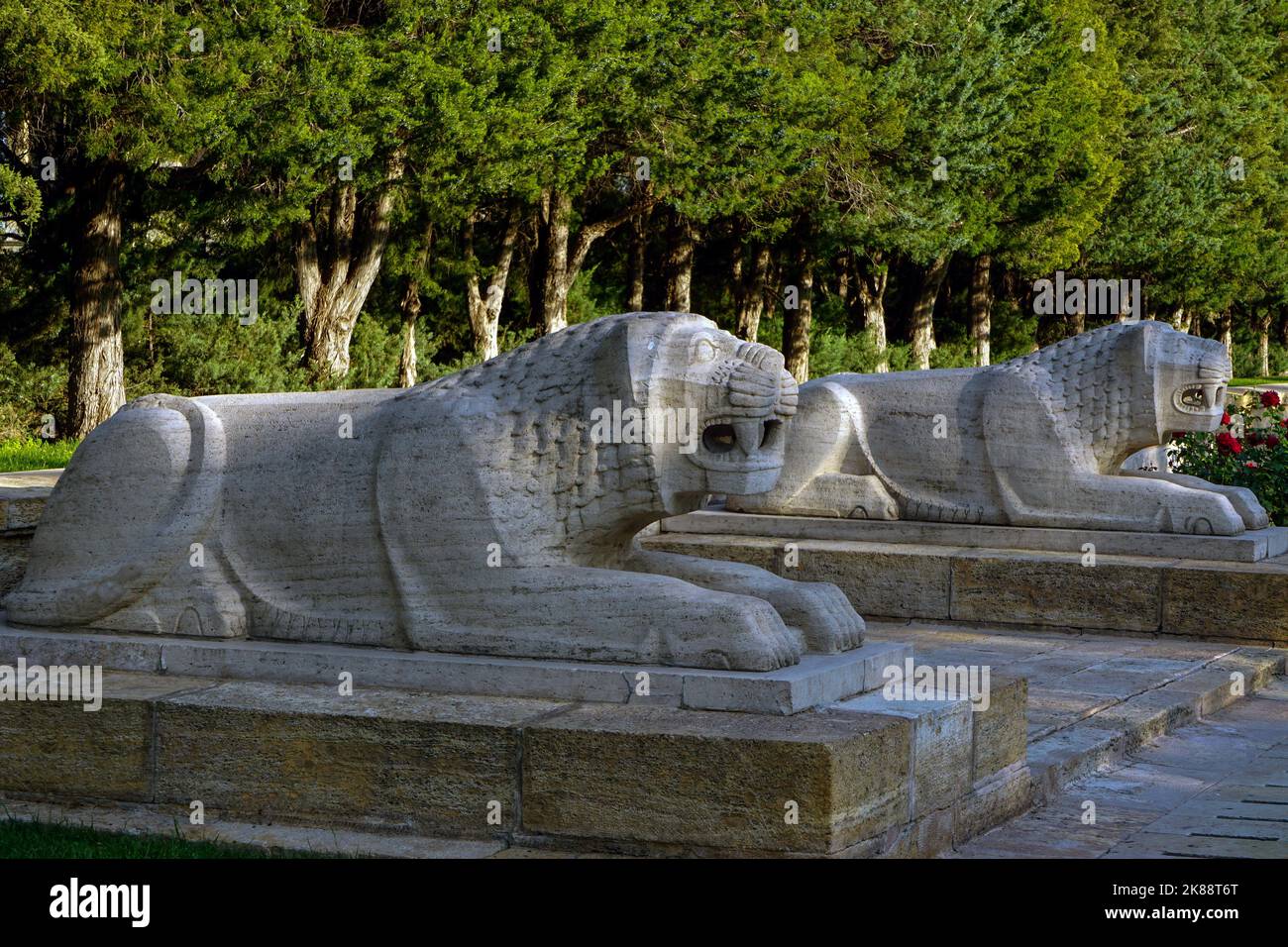 The Anitkabir lion road statues against the background of green trees ...