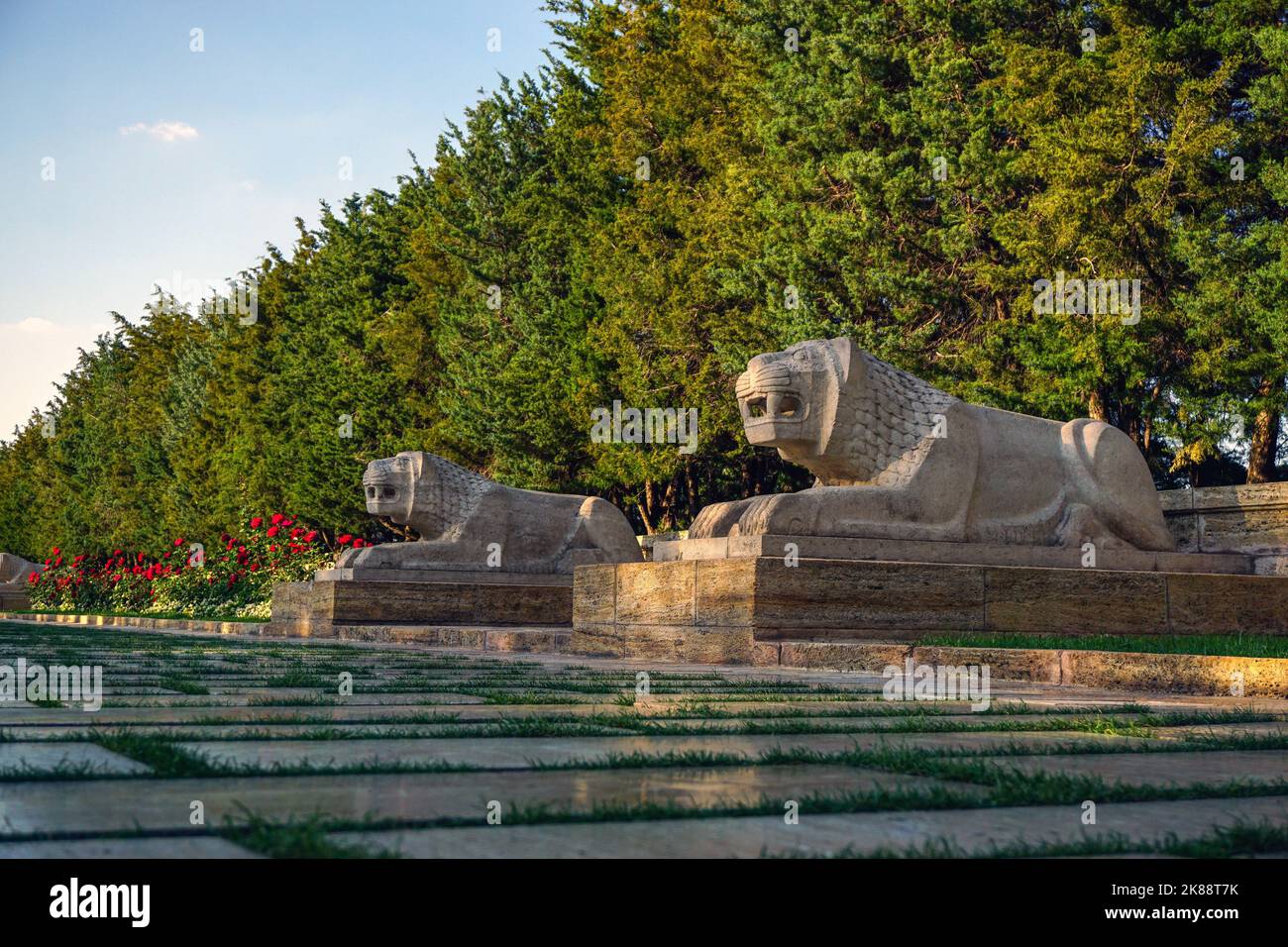 The Anitkabir lion road statues against the background of green trees ...