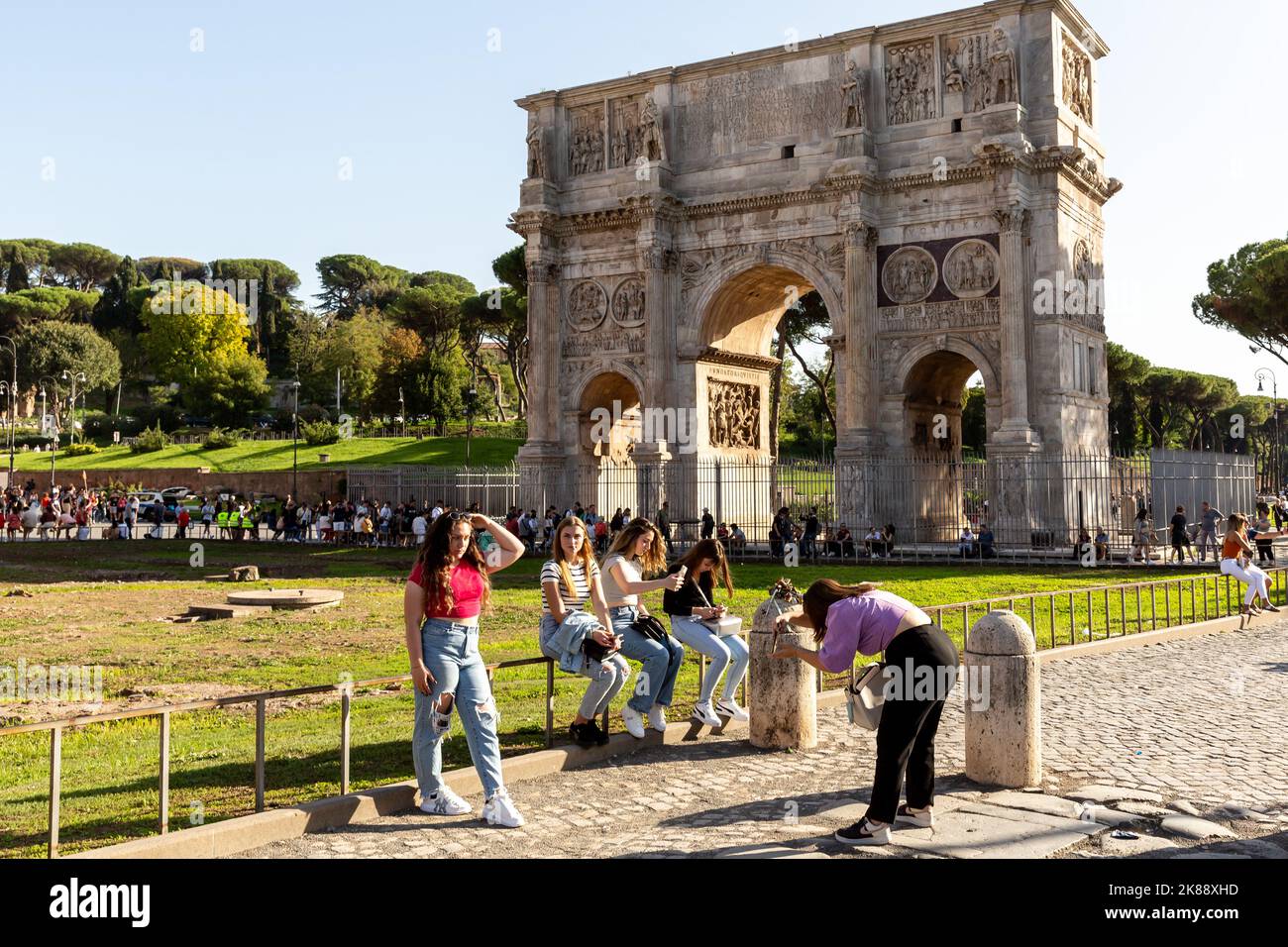 Tourist are seen on the street on a sunny day by the Arch of ...