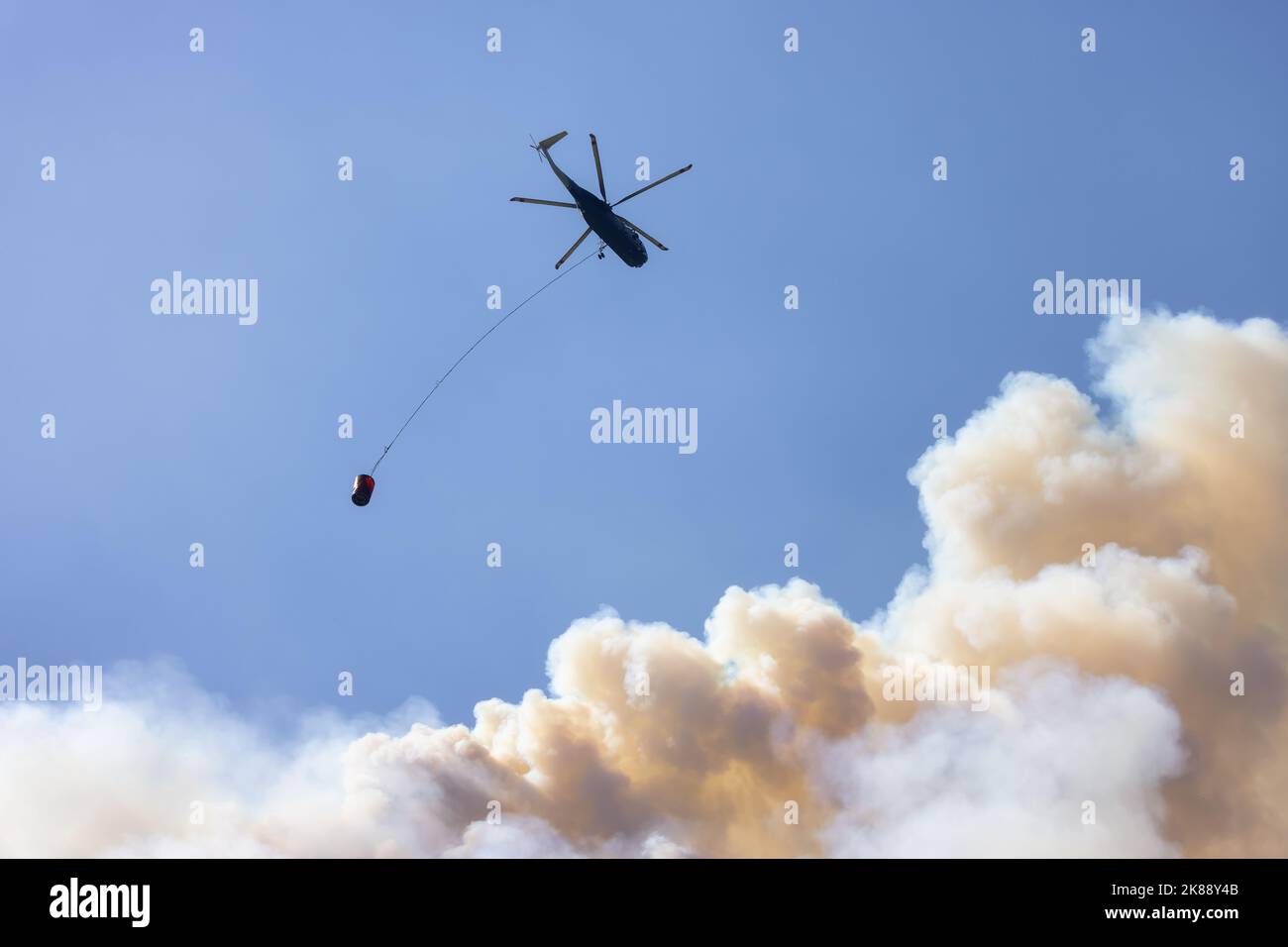 Wildfire Service Helicopter flying over BC Forest Fire and Smoke on the ...
