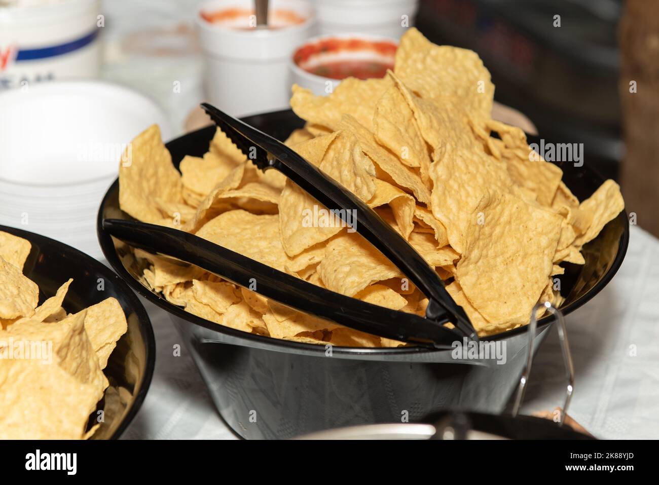 Large bowl of chips are ready to be served by the guests using the ...