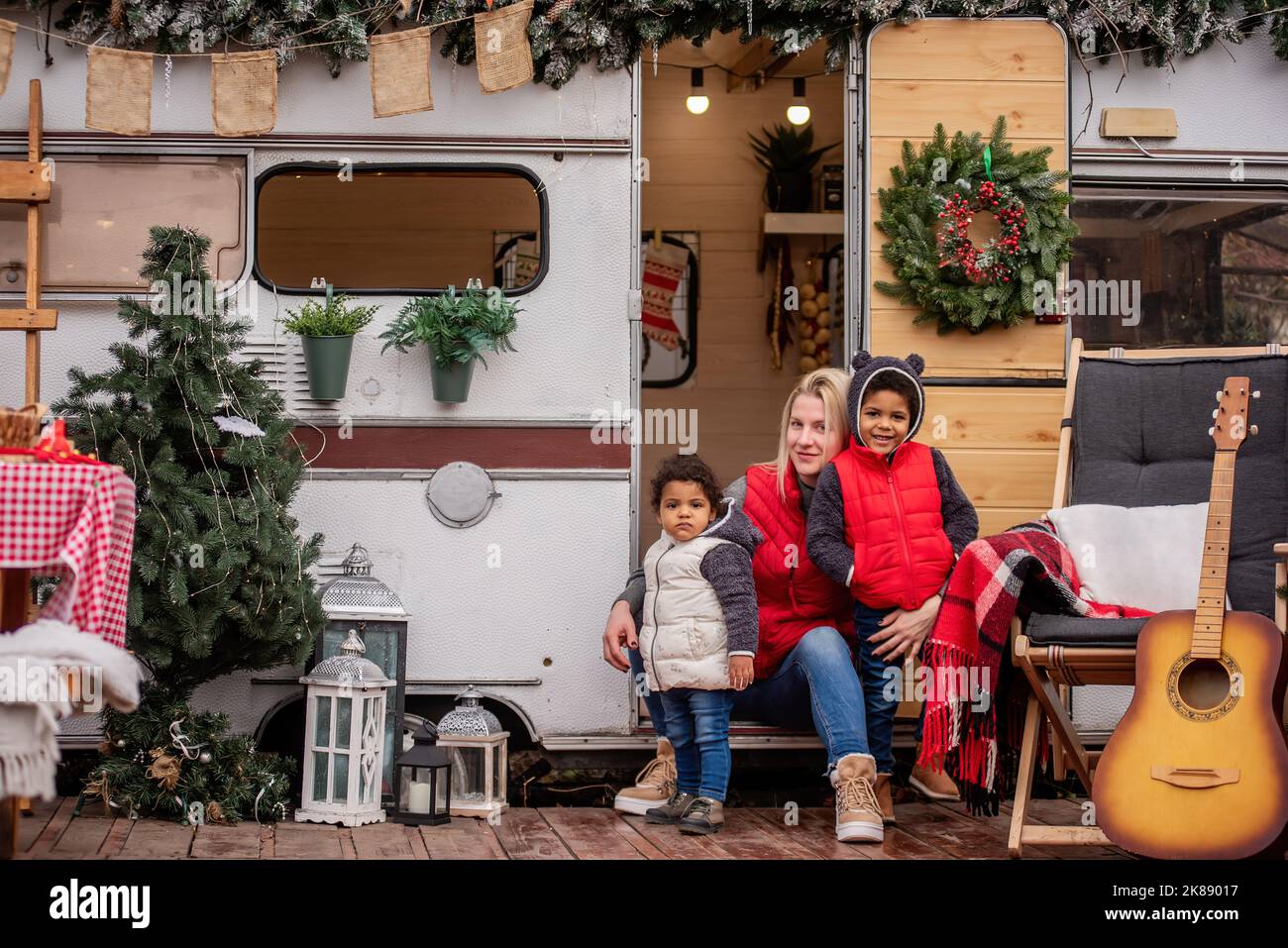 Caucasian mother plays having fun with African American children on the ...