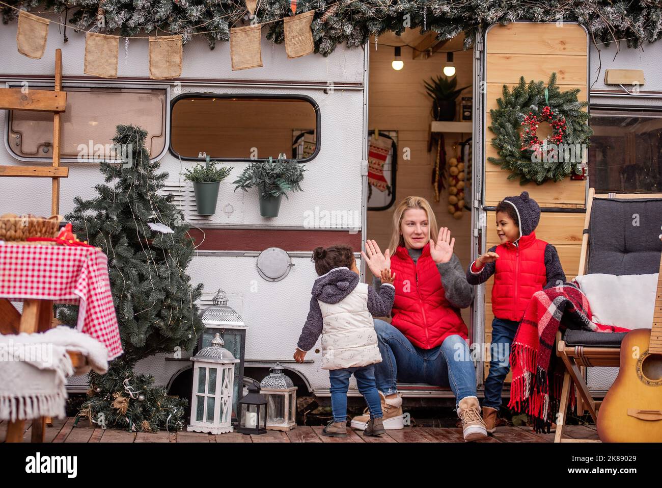 Caucasian mother plays, having fun with African American children on ...
