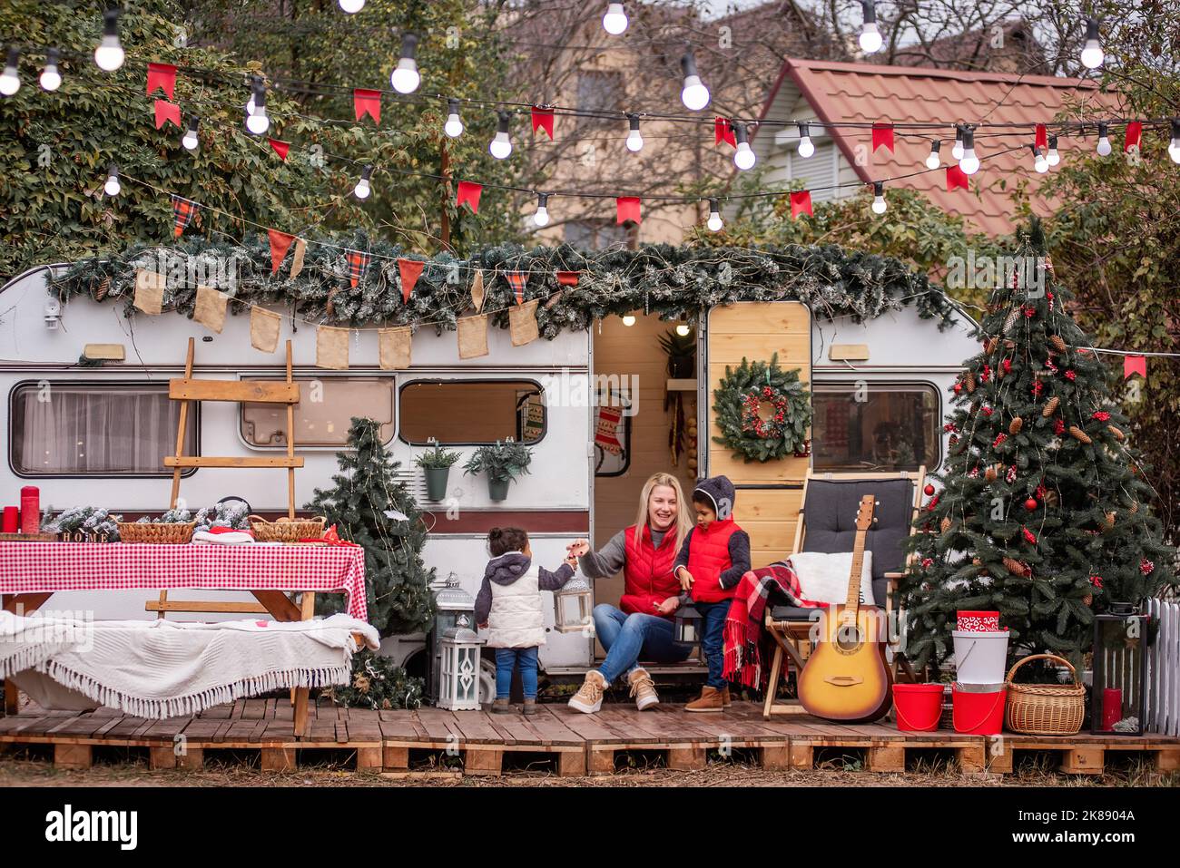 Caucasian mother plays having fun with African American children on the ...