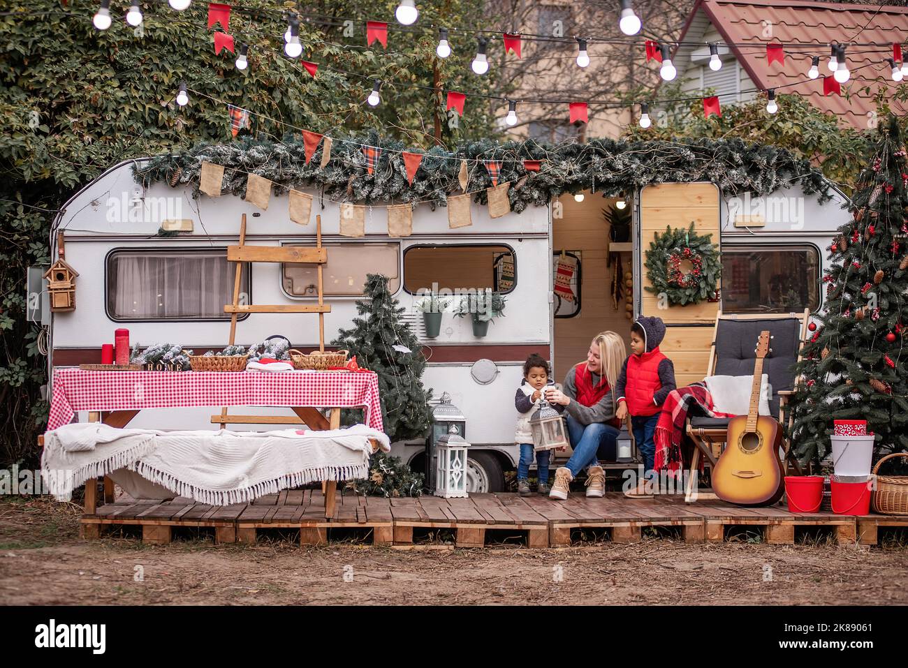 Caucasian mother plays having fun with African American children on the ...