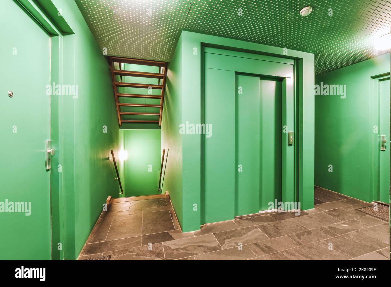 Shiny elevator with opened door located in illuminated hall of ...