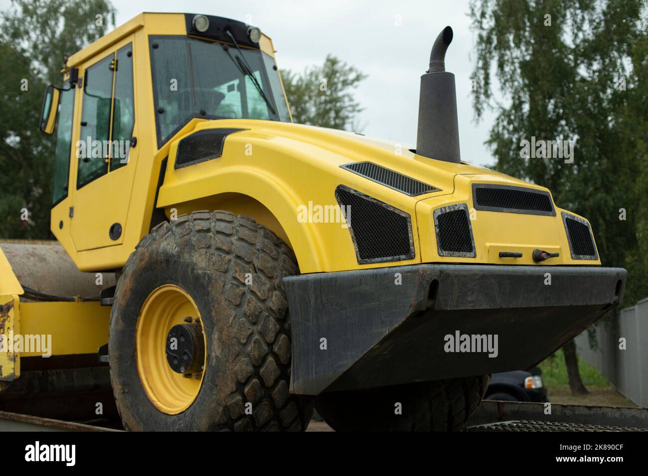 Transportation on platform of heavy machinery. Yellow tractor ...