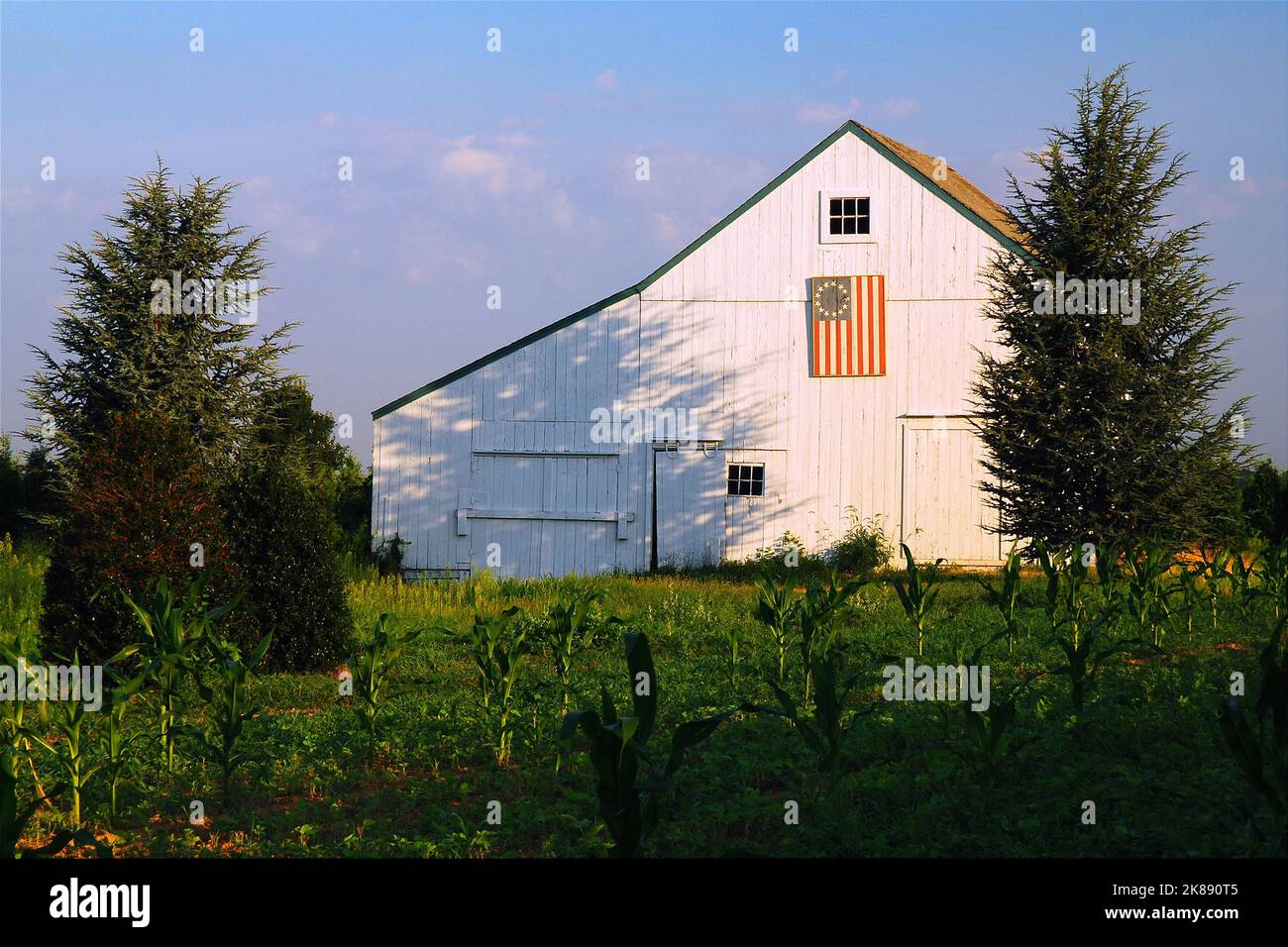A colonial American flag is placed on the front of a barn, displaying ...