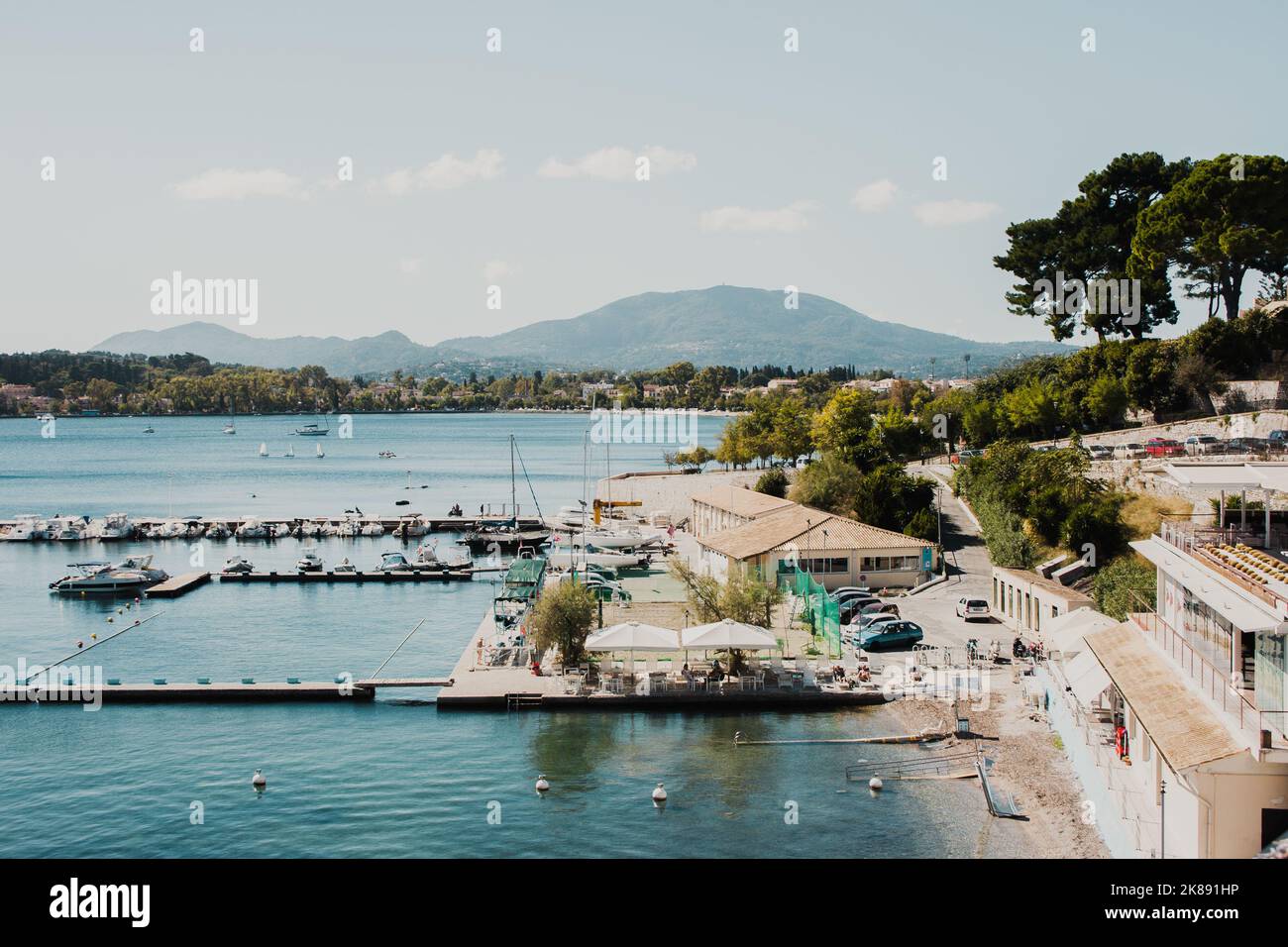 Lake shore with houses in Greece. Boat docks in the lake Stock Photo ...