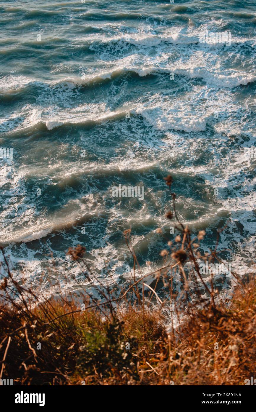 View of blue water with huge waves and white foam crashing on the shore ...