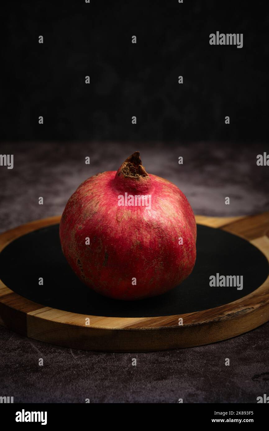 juicy pomegranate on a dark background Stock Photo - Alamy