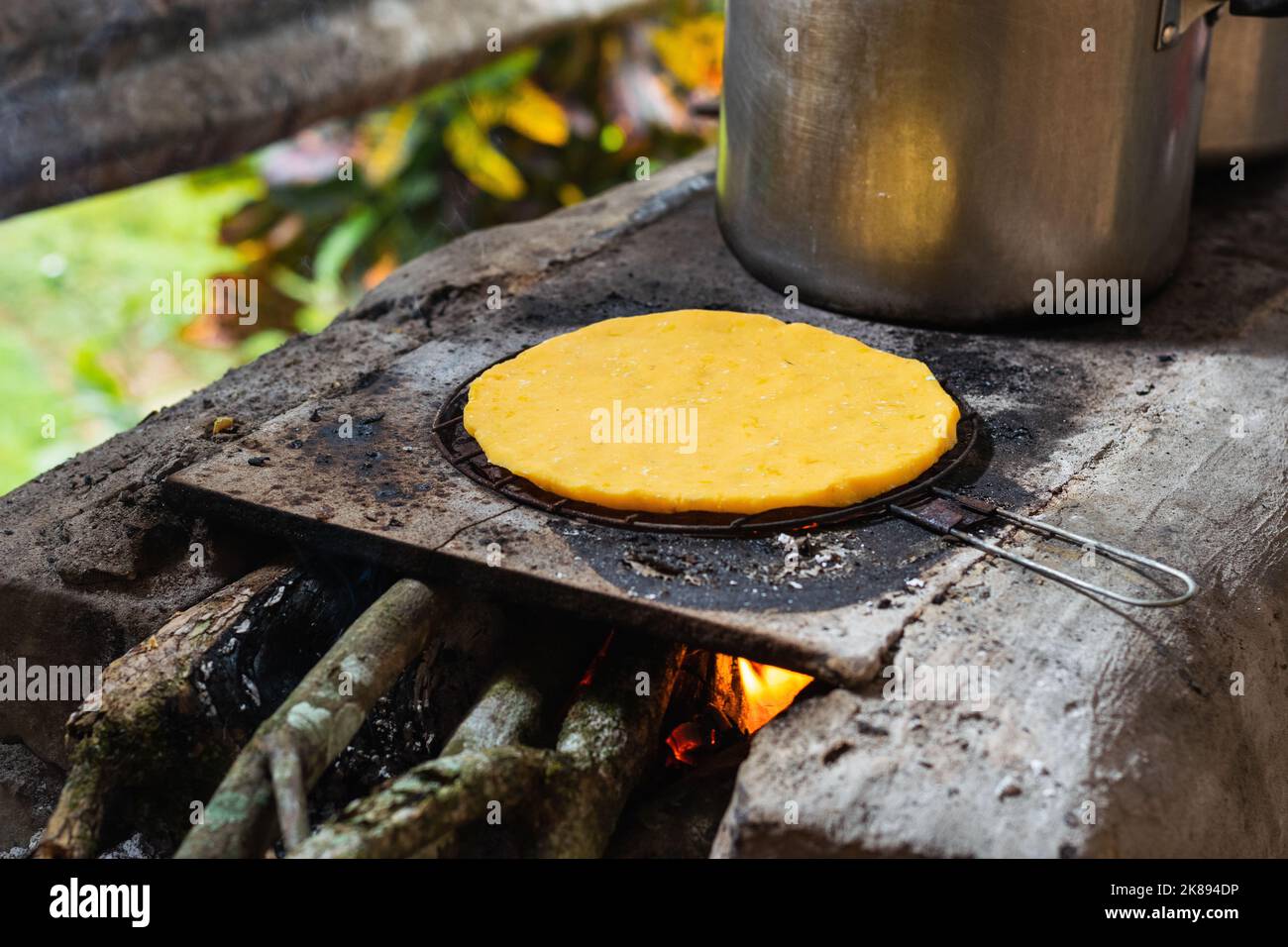 grill with a traditional Colombian yellow arepas on top of a handmade ...