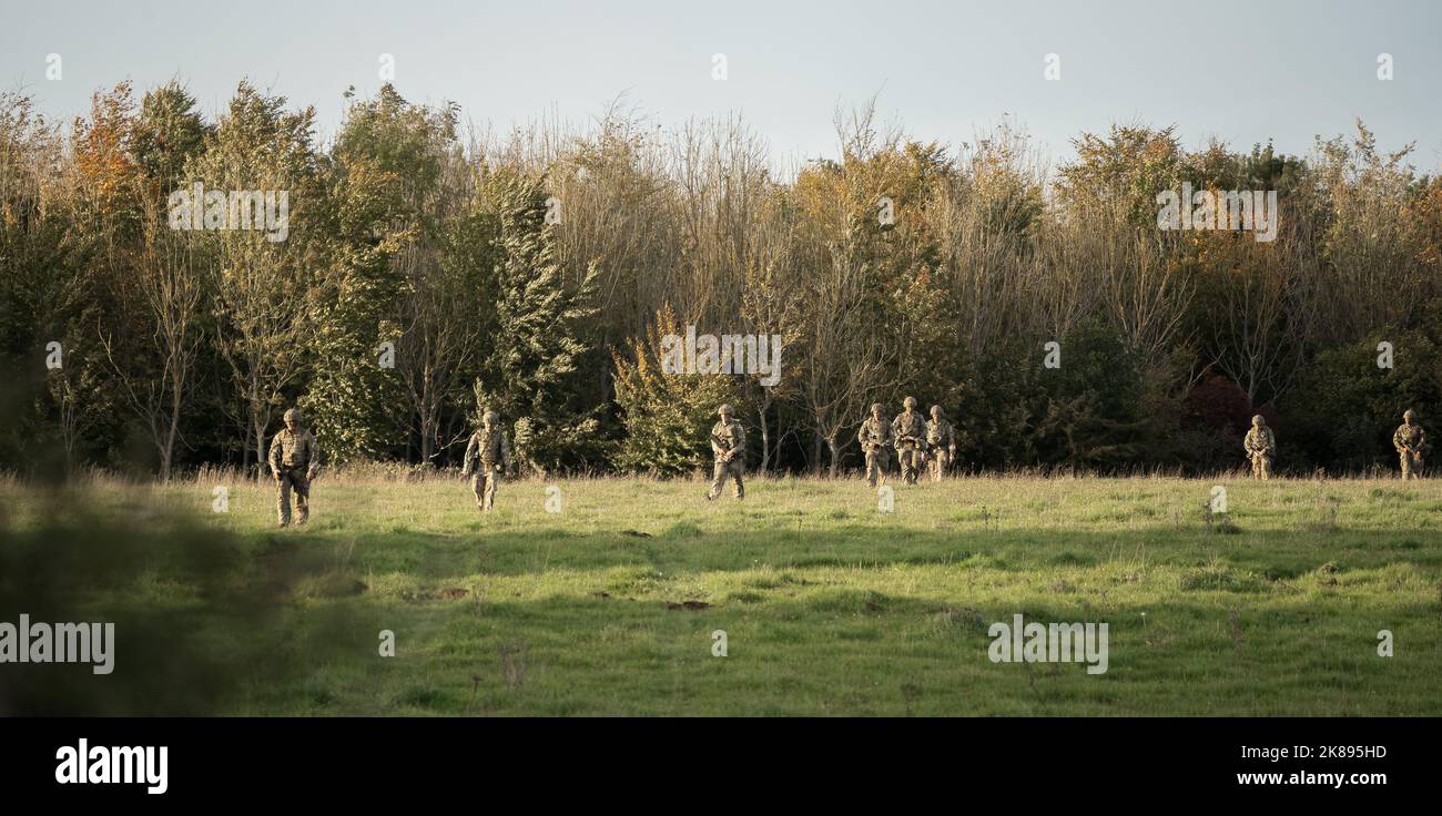 British army soldiers crossing open ground, weapons ready on a military ...