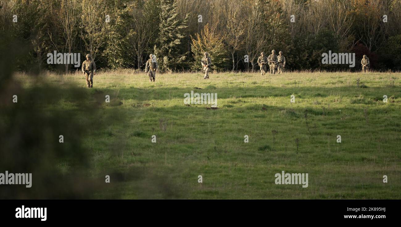 British army soldiers crossing open ground, weapons ready on a military ...