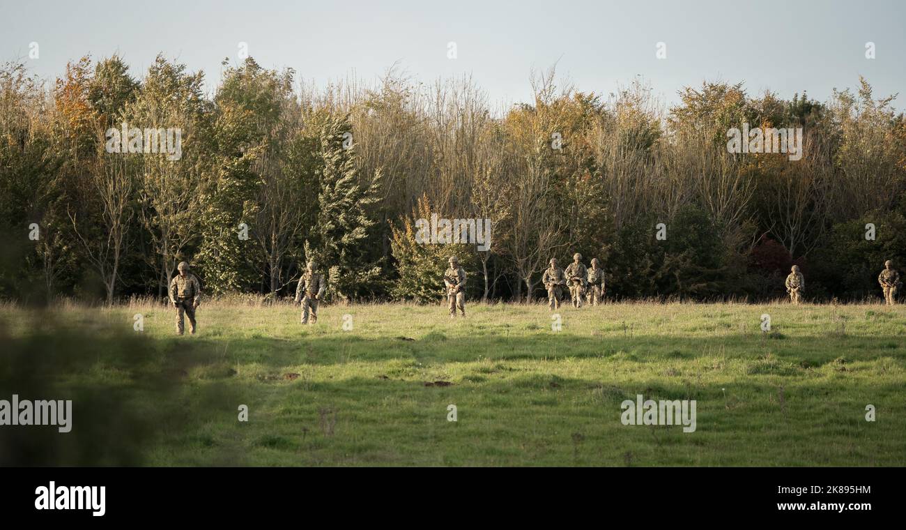 British army soldiers crossing open ground, weapons ready on a military ...