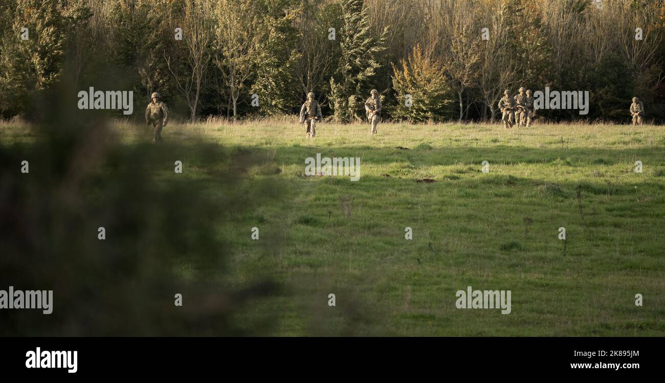 British army soldiers crossing open ground, weapons ready on a military ...