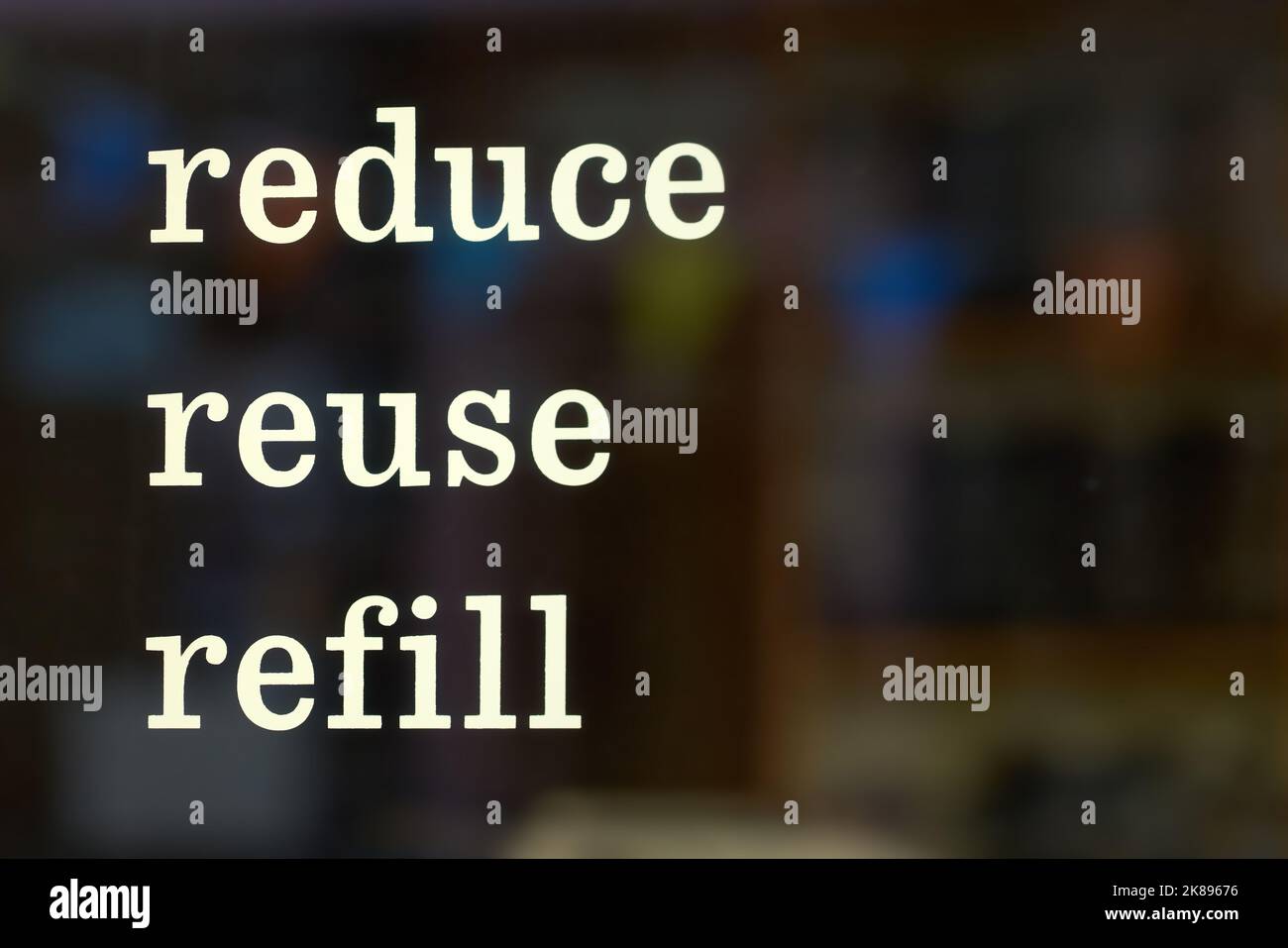 A shop sign with the words reduce, reuse, refill promoting ...