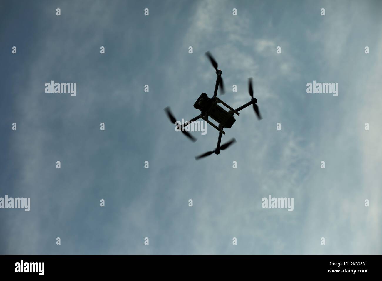 Drone in sky. Quadro copter flies in air. Surveillance from height ...