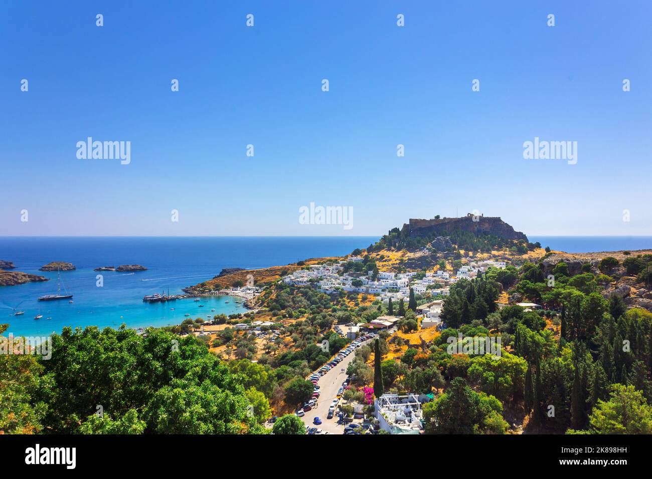 Panoramic view of colorful harbor in Lindos village and Acropolis ...