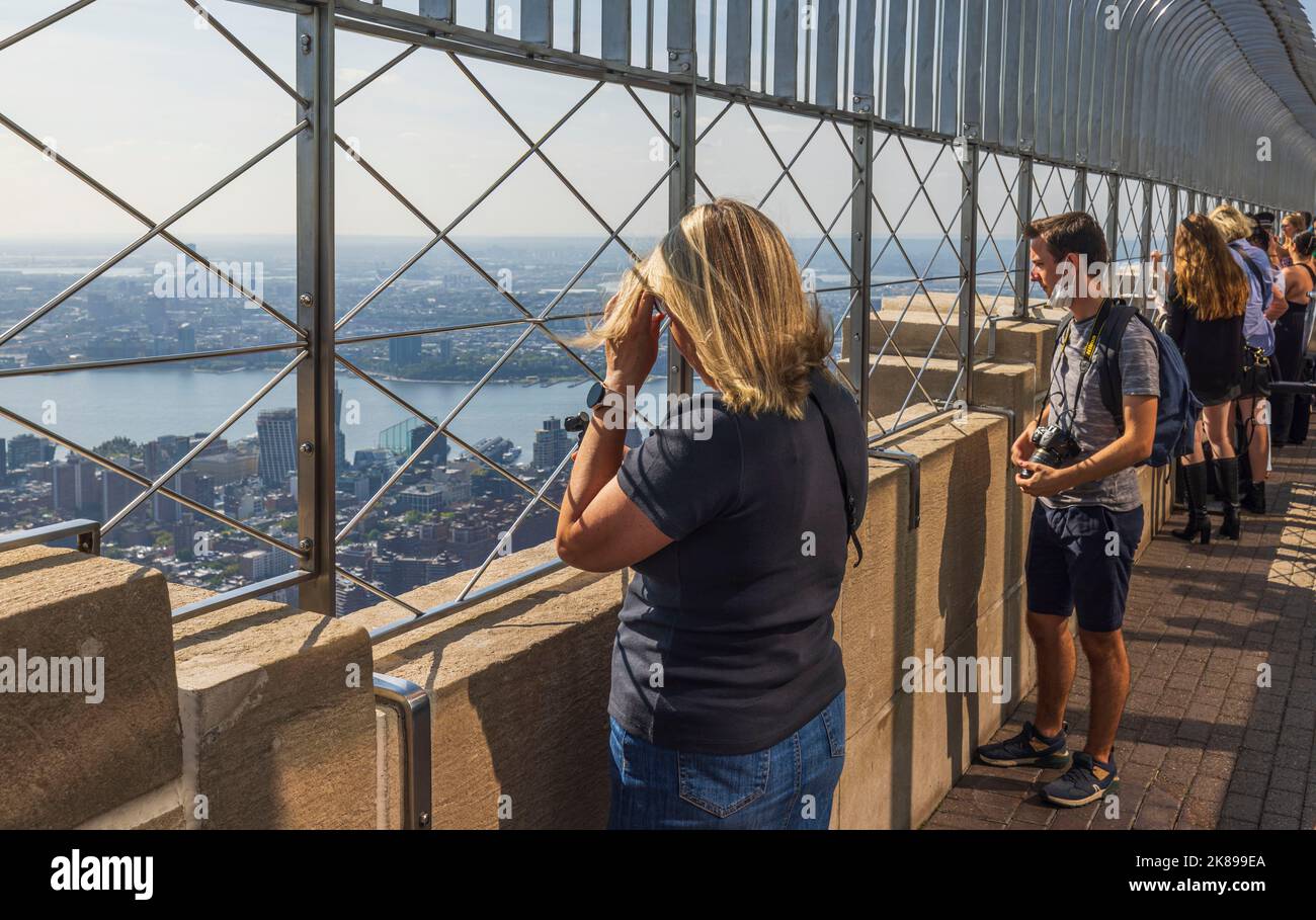 Woman filming on video camera view of Manhattan from Empire State ...
