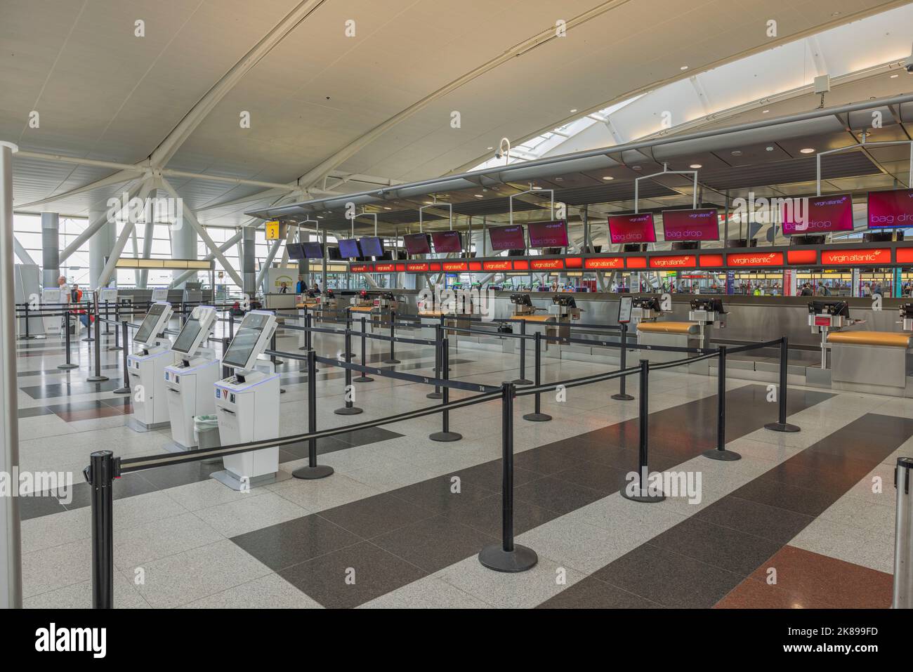 Interior view of airport with check-in counters for flight and baggage ...
