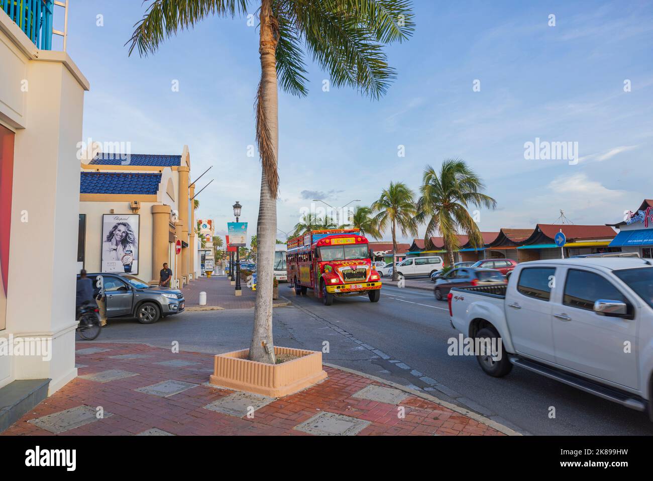 Beautiful view of Oranjestad city downtown with passing cars and tour ...