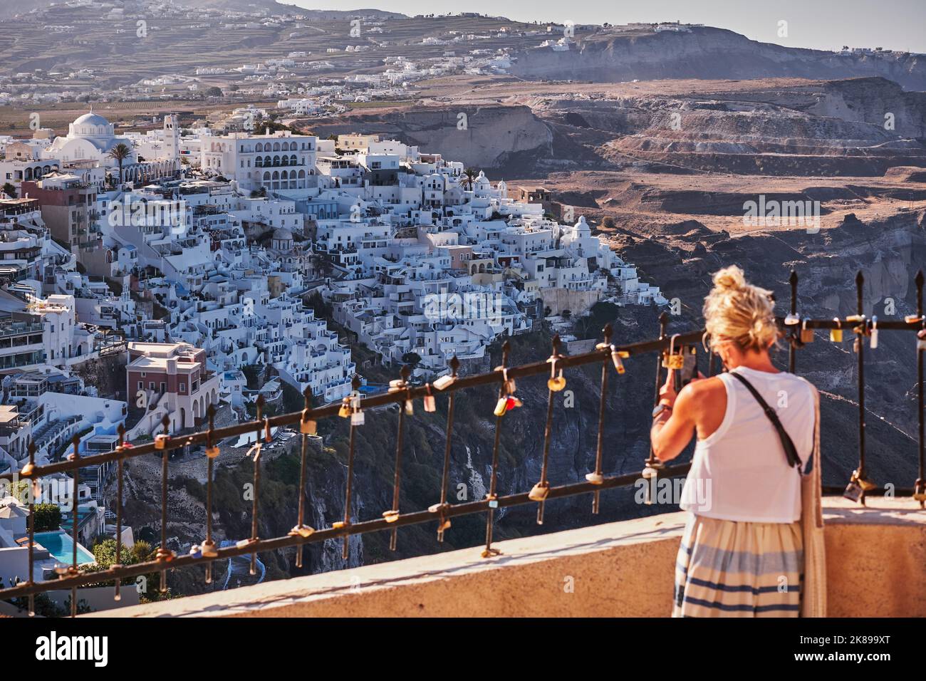 Young Woman Taking a Photo near Love Locks on a Railing - Fira Village ...