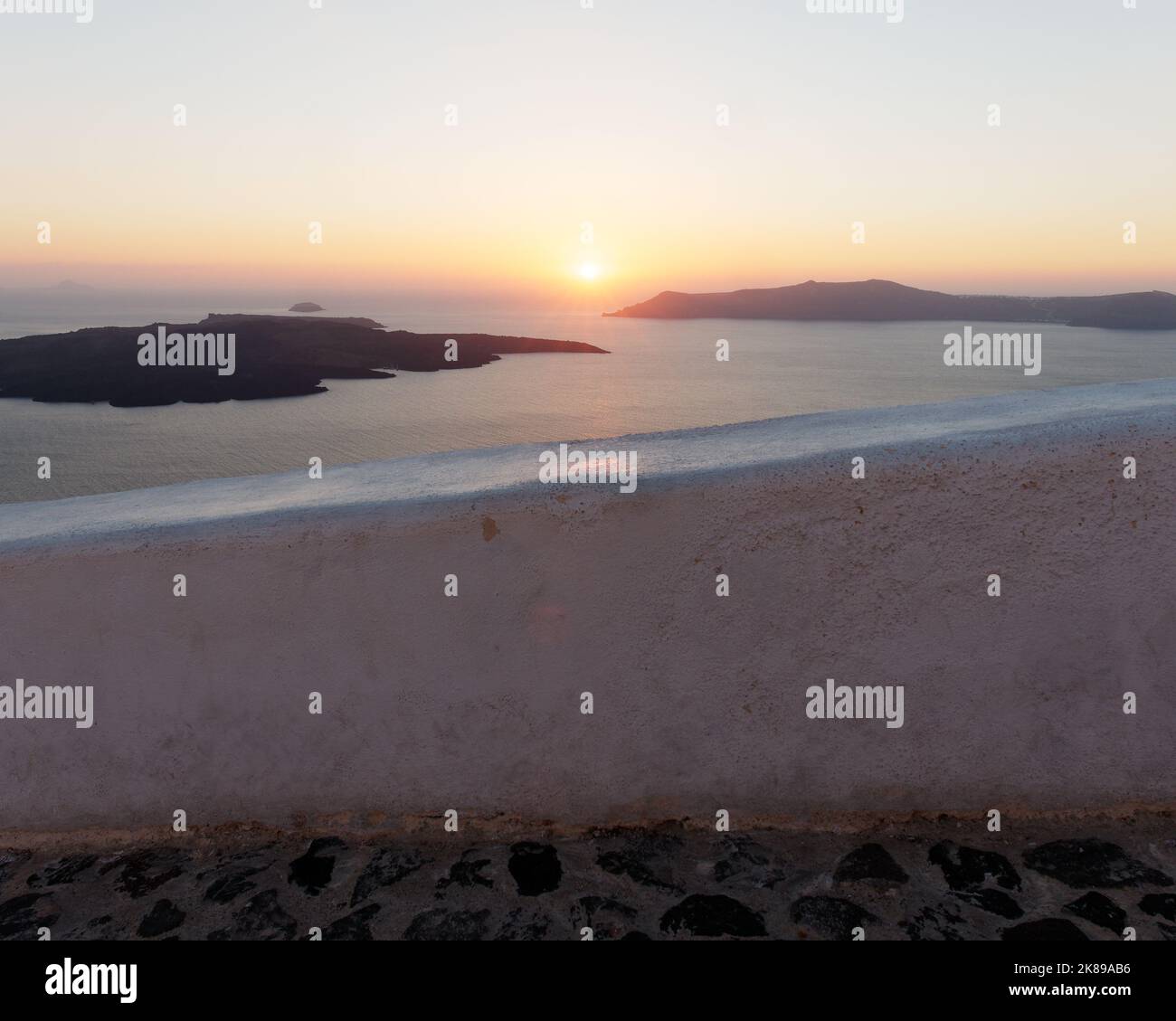Sunset over Thirasia from a a coastal path in Fira. Greek Aegean ...