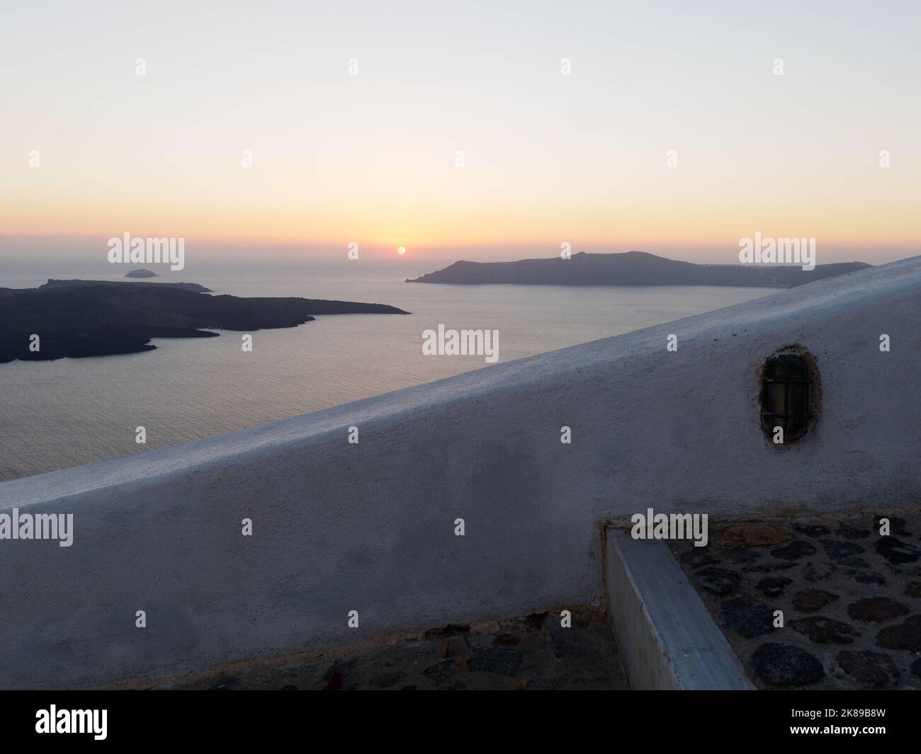 Sunset over Thirasia from a a coastal path in Fira. Greek Aegean ...